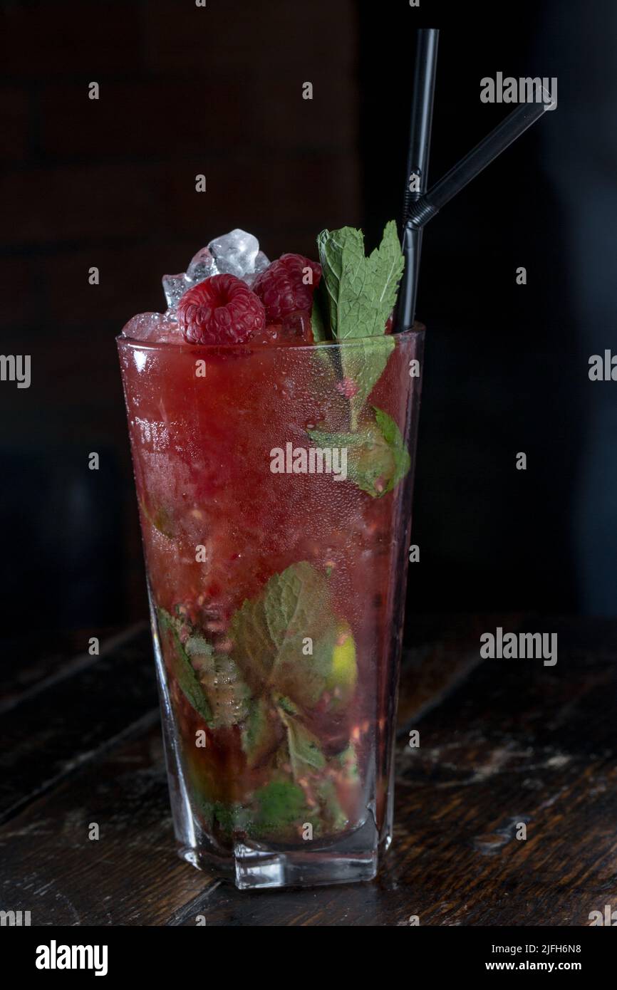 A mixed fruit drink with lots of ice and pepper mint leaf on top Stock ...