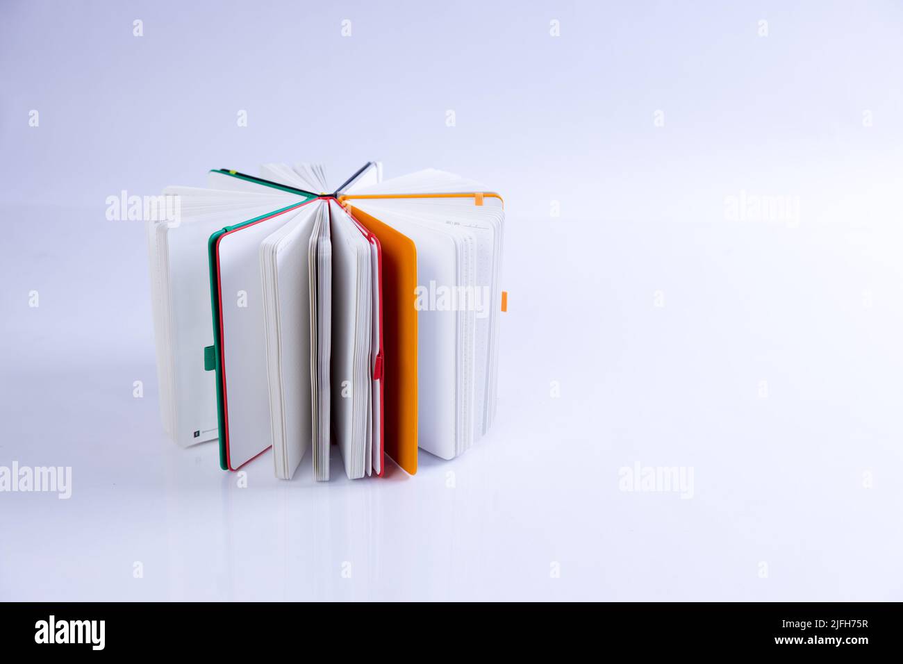 Colorful journals placed together like a flower. Beautiful studio photo ...