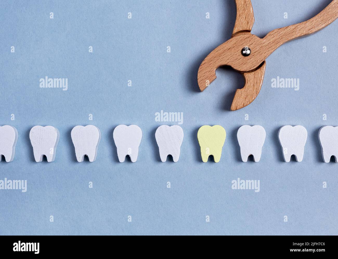 Extracting caries tooth from healthy teeth row. High quality photo ...