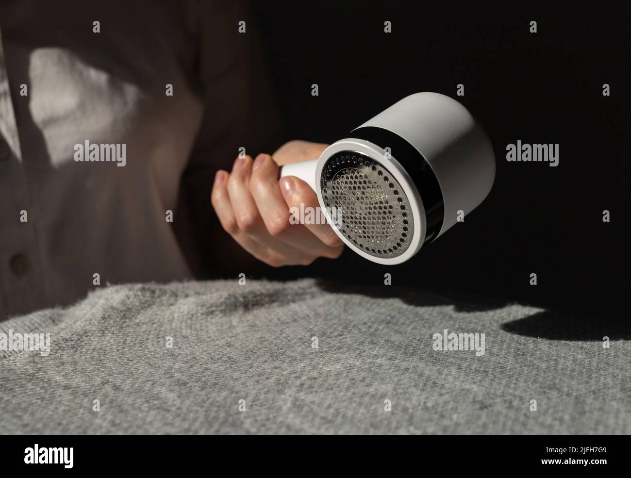 Woman cleaning clothes lint hi-res stock photography and images - Alamy