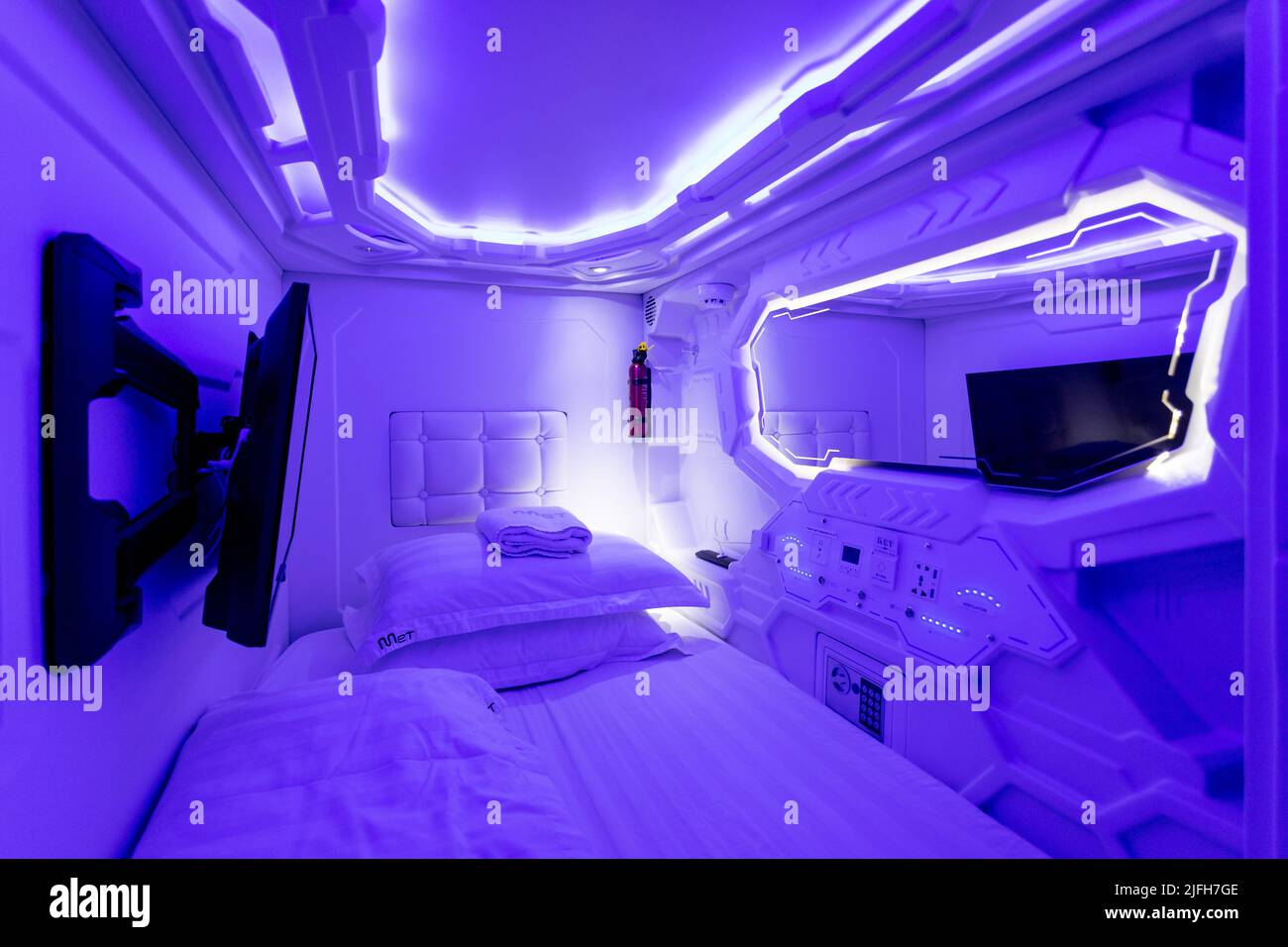 An Interior of a creative illuminated capsule hotel Stock Photo - Alamy