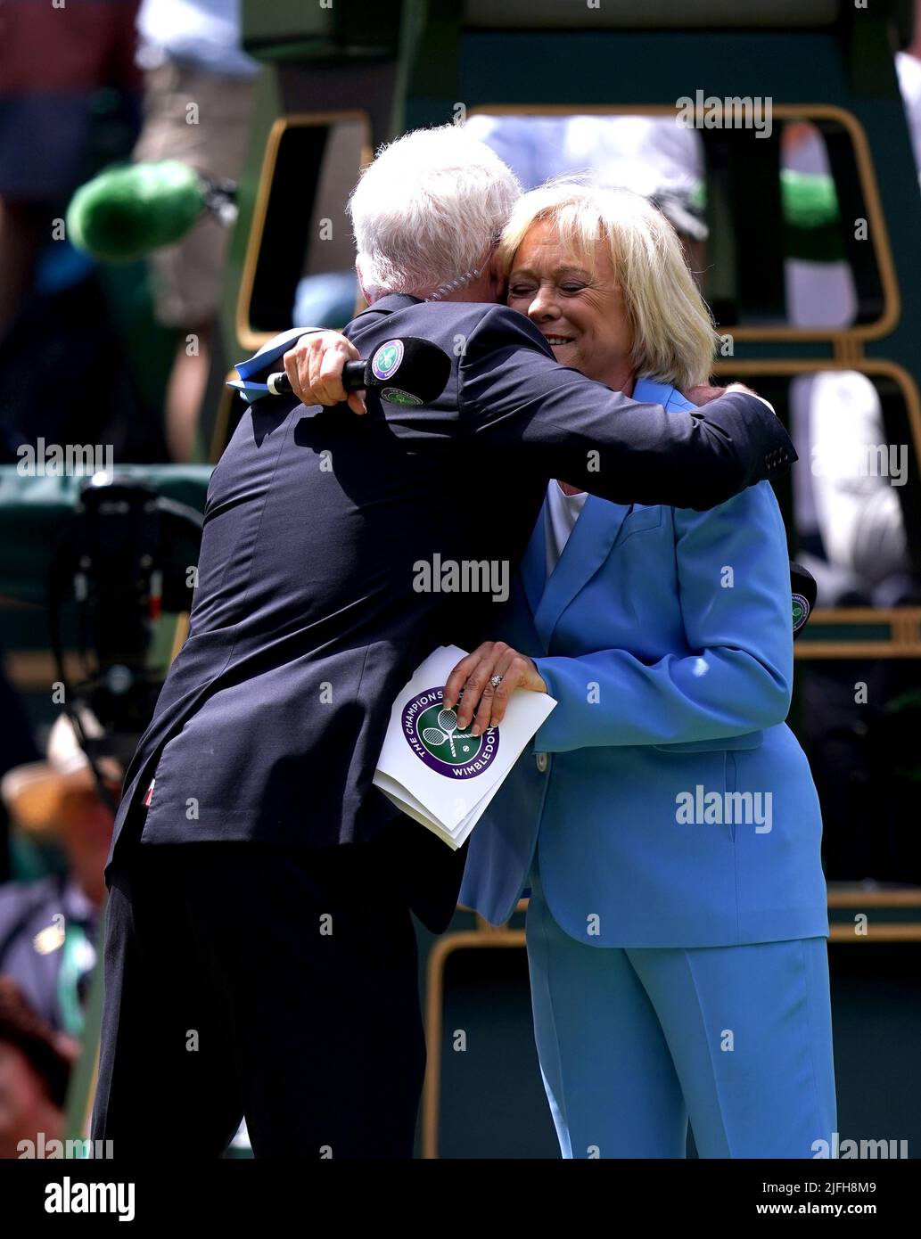 Sue Barker is hugged by John McEnroe on centre court during day seven of the 2022 Wimbledon ...