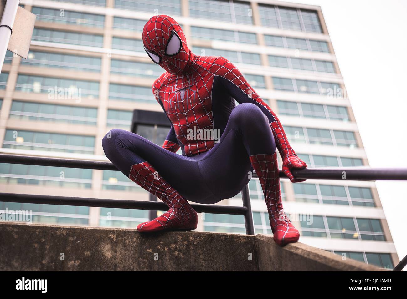 A closeup shot of Spider-Man standing on wall and looking down Stock ...