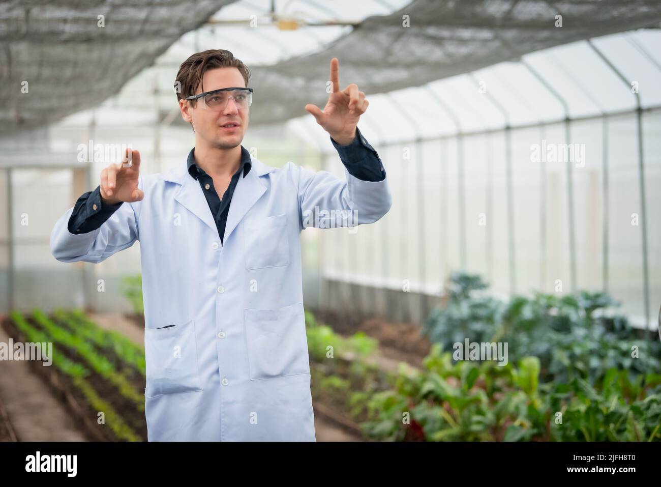 Portrait of handsome agricultural researcher working on research at ...
