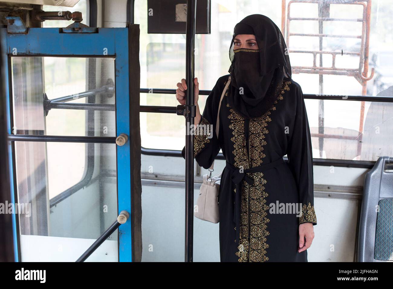 Muslim woman in public transport going to work Stock Photo - Alamy