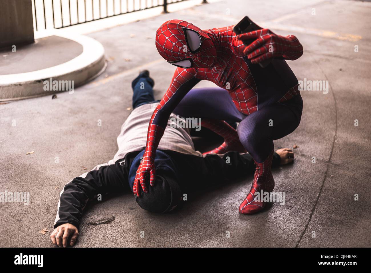 Spider-man is taking a selfie with defeated villain. Famous superhero ...