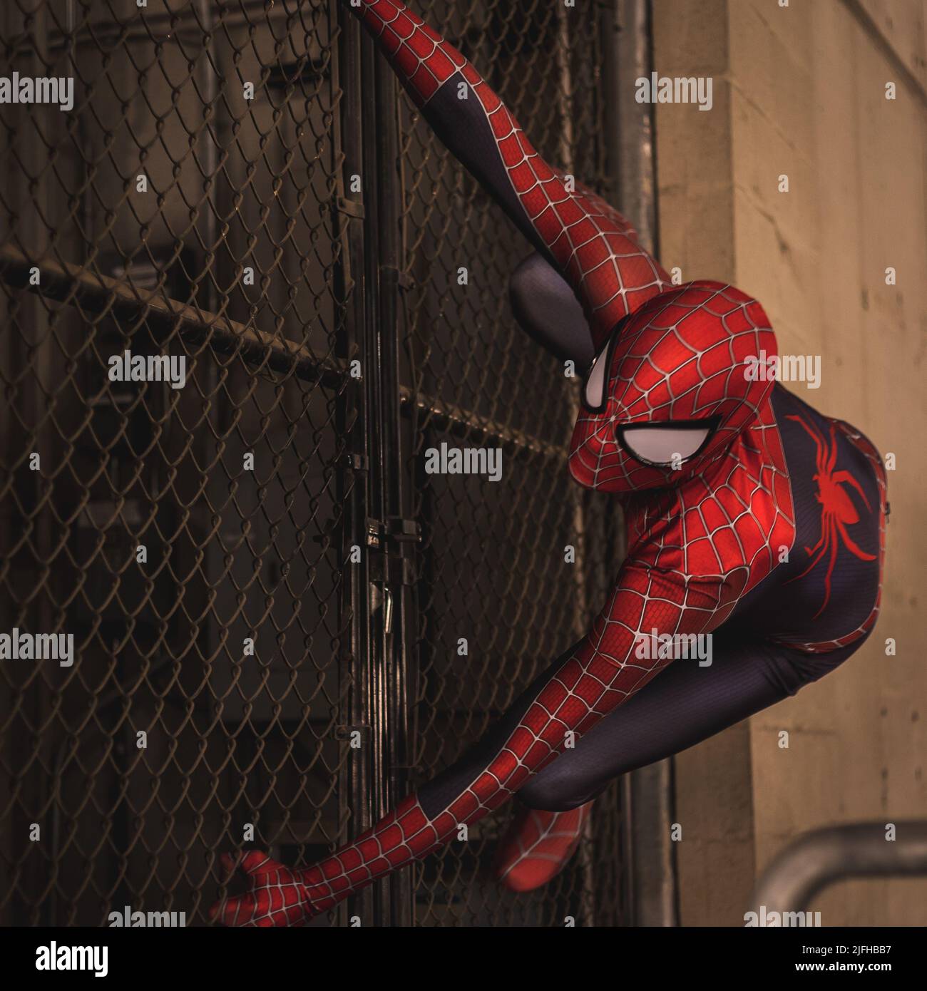 Spider-man crawling up a wall. Famous superhero visiting downtown Fort ...