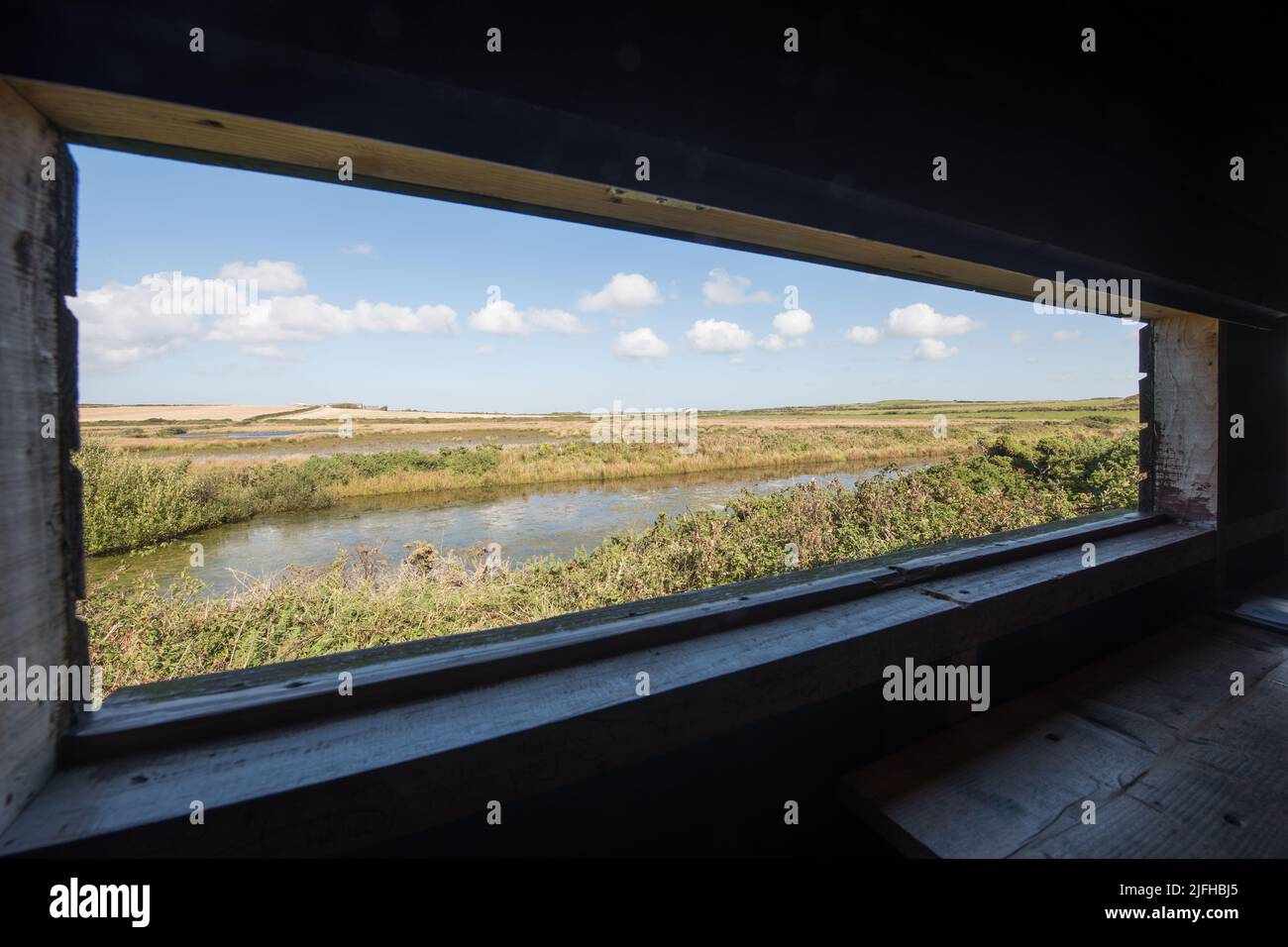 View through window of bird hide at MArloes Mere, Pembrokeshire, Wales ...