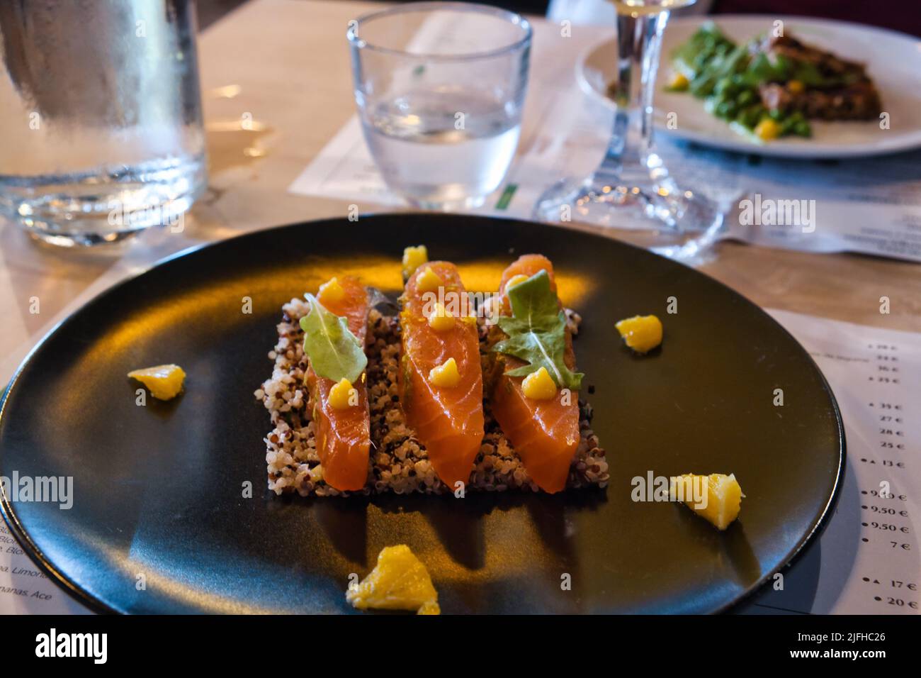 Simple dish with slices of red salmon carpaccio and seeds Stock Photo ...