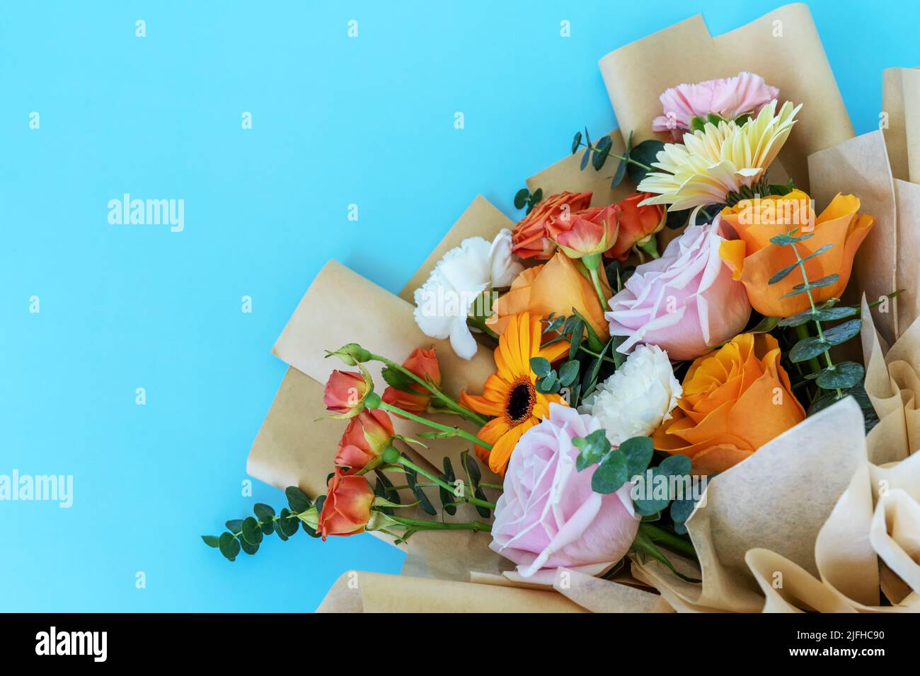 Mixed flower bouquet on blue background with copy space Stock Photo - Alamy