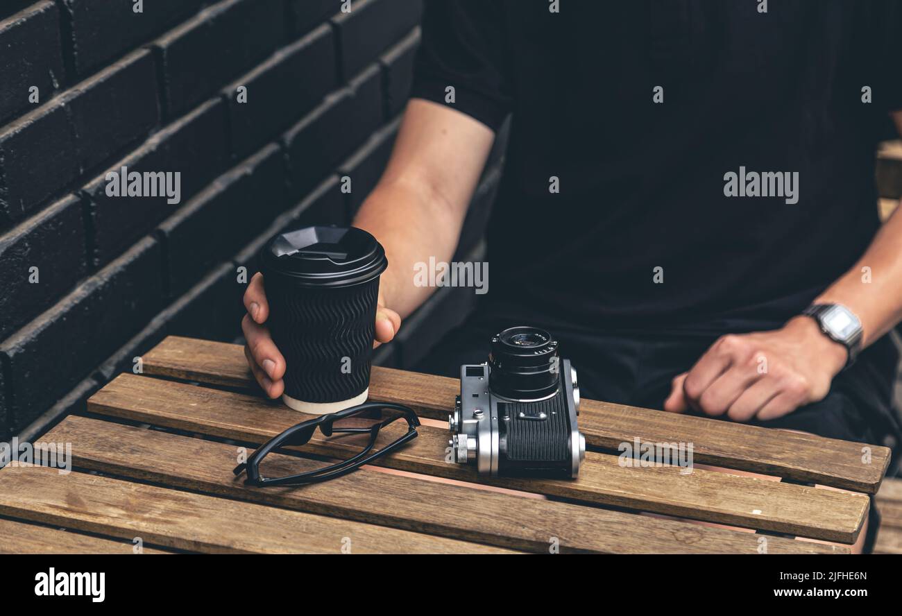Vintage film camera and a glass of coffee on a wooden table Stock Photo ...