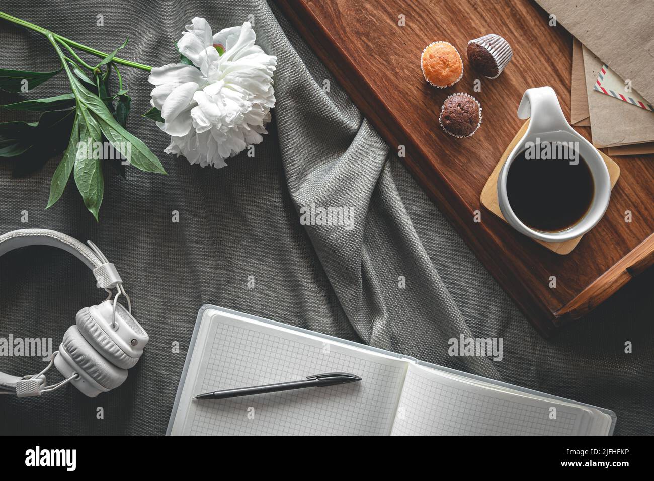 Flat lay composition in bed, with coffee and notepad Stock Photo - Alamy