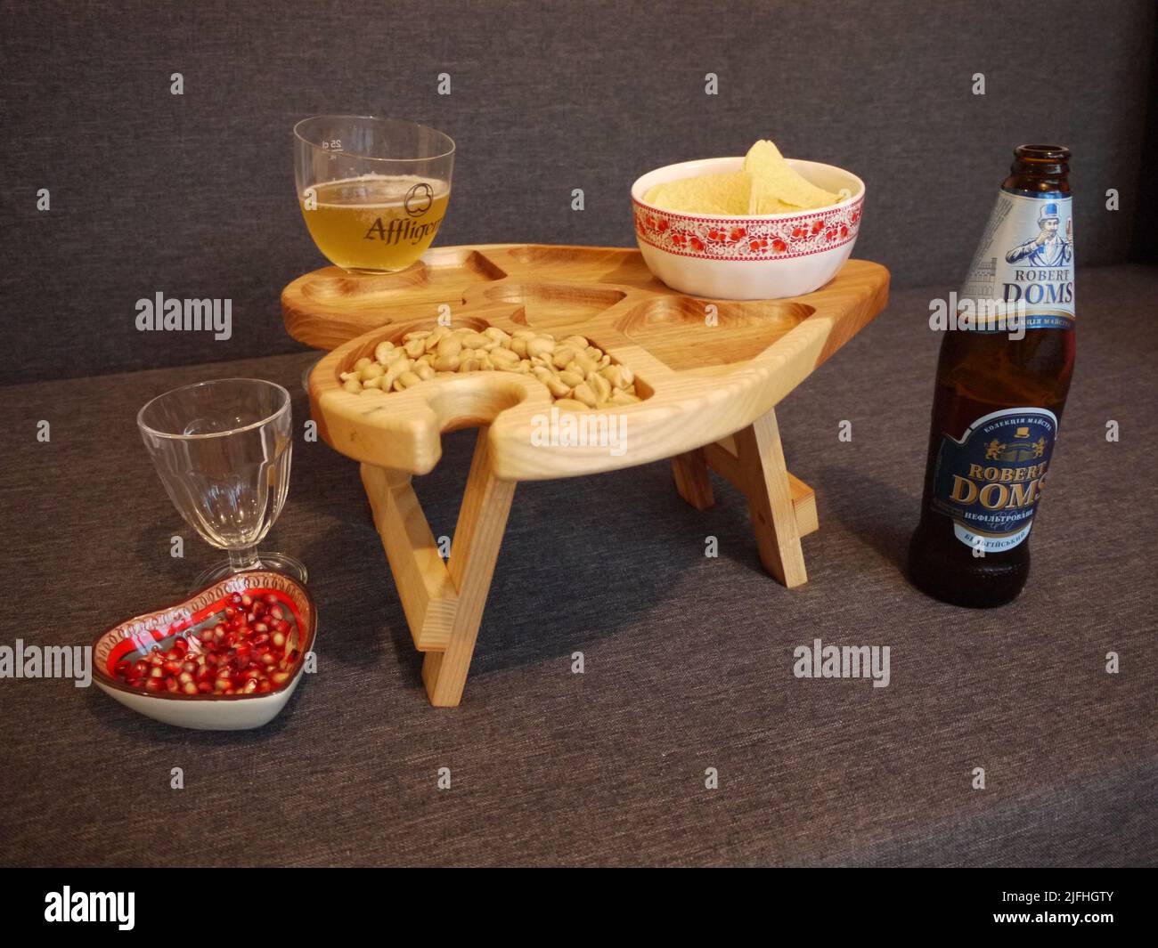 A wooden appetizer table with beer and crisps Stock Photo - Alamy