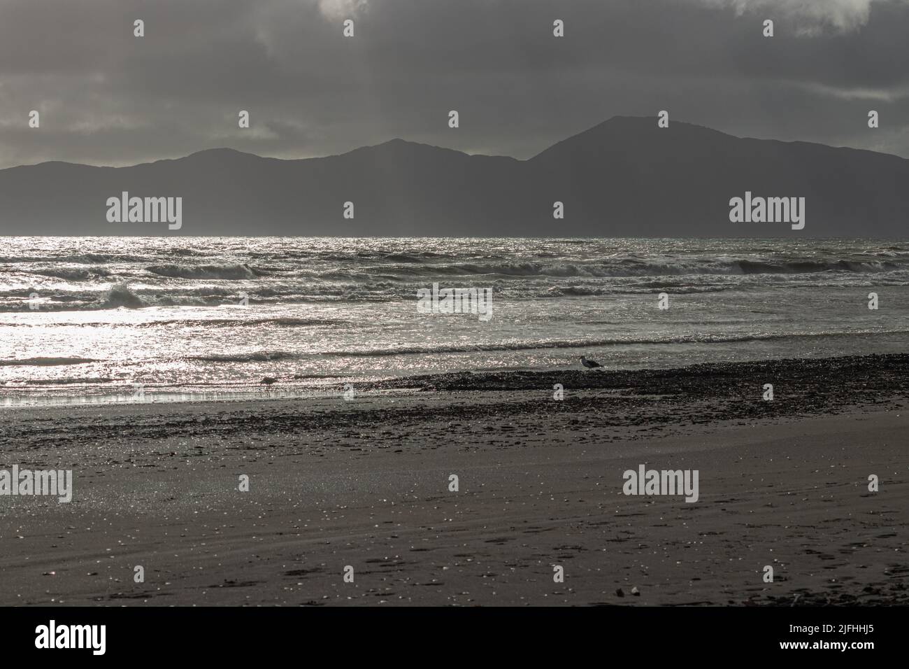 Sunlit sea under heavy cloud cover Stock Photo - Alamy