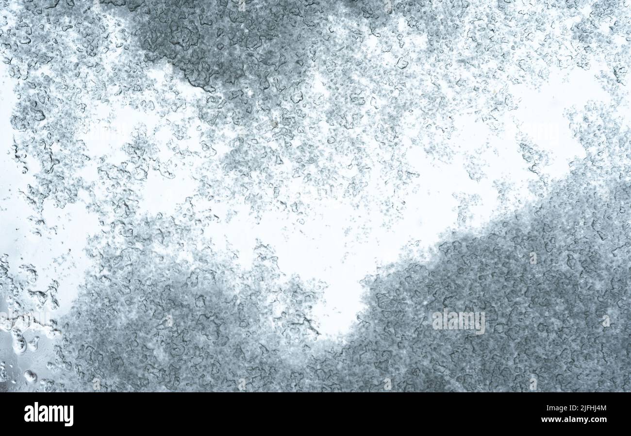 Snow creating texture on the glass. Structure of snow flakes and ice ...