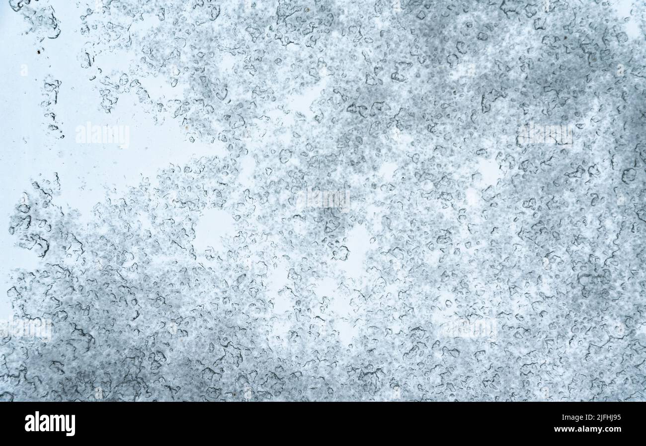 Snow creating texture on the glass. Structure of snow flakes and ice ...