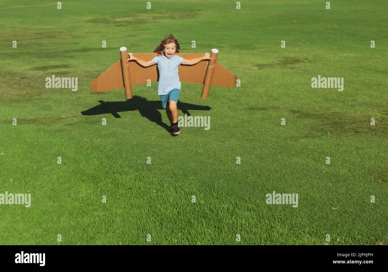 Kid imagination, child pilot with paper wings having fun at outdoor ...