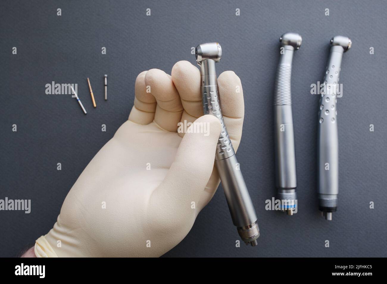 Dentist hand holding dental handpiece close-up Stock Photo - Alamy
