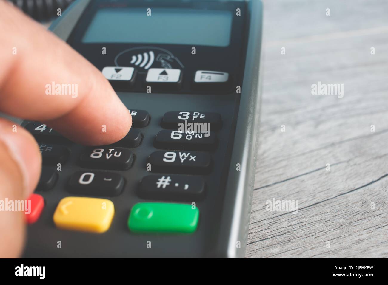 A closeup of the person's hand entering the code into the micro ATM ...