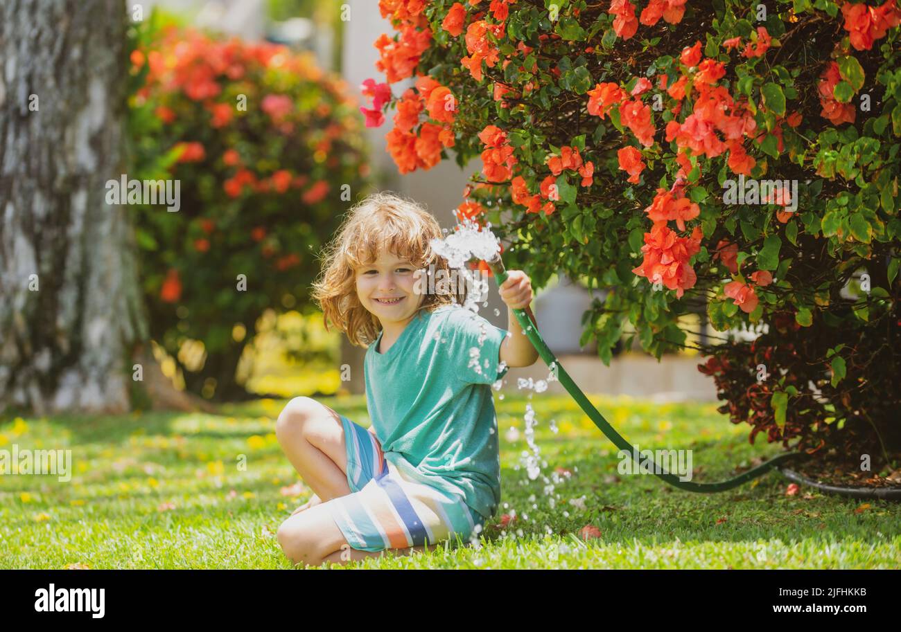Kids play with water garden hose in yard. Outdoor children summer fun ...
