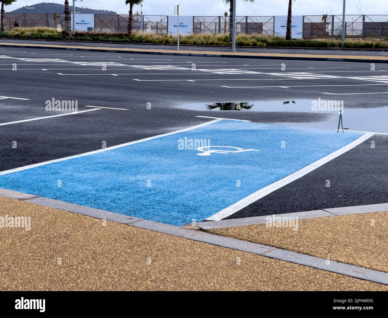 Disabled parking space in an empty outdoor parking lot Stock Photo - Alamy