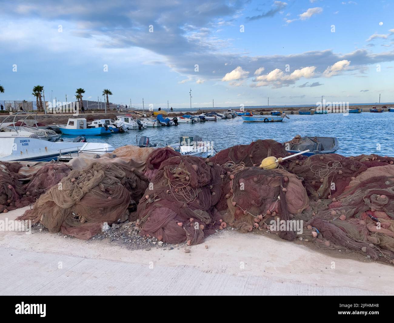 Fishing nets on the floor in a small harbor Stock Photo - Alamy