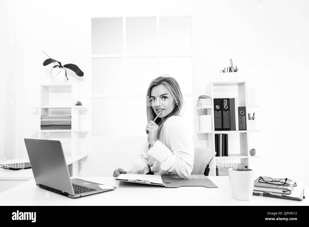 Portrait of young friendly and smiling secretary Stock Photo - Alamy