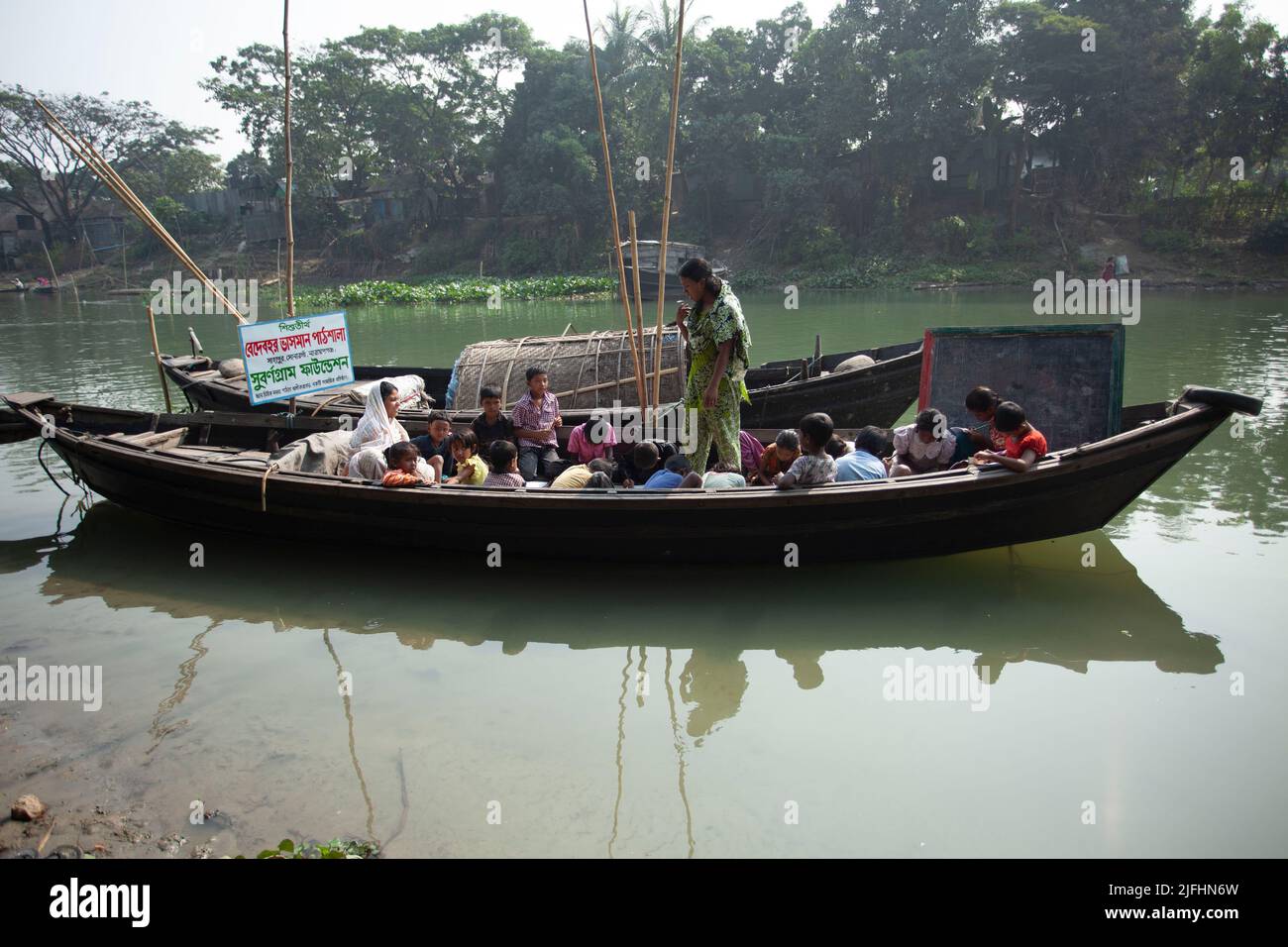 A floating school on a small boat for gypsy children on a canal near ...