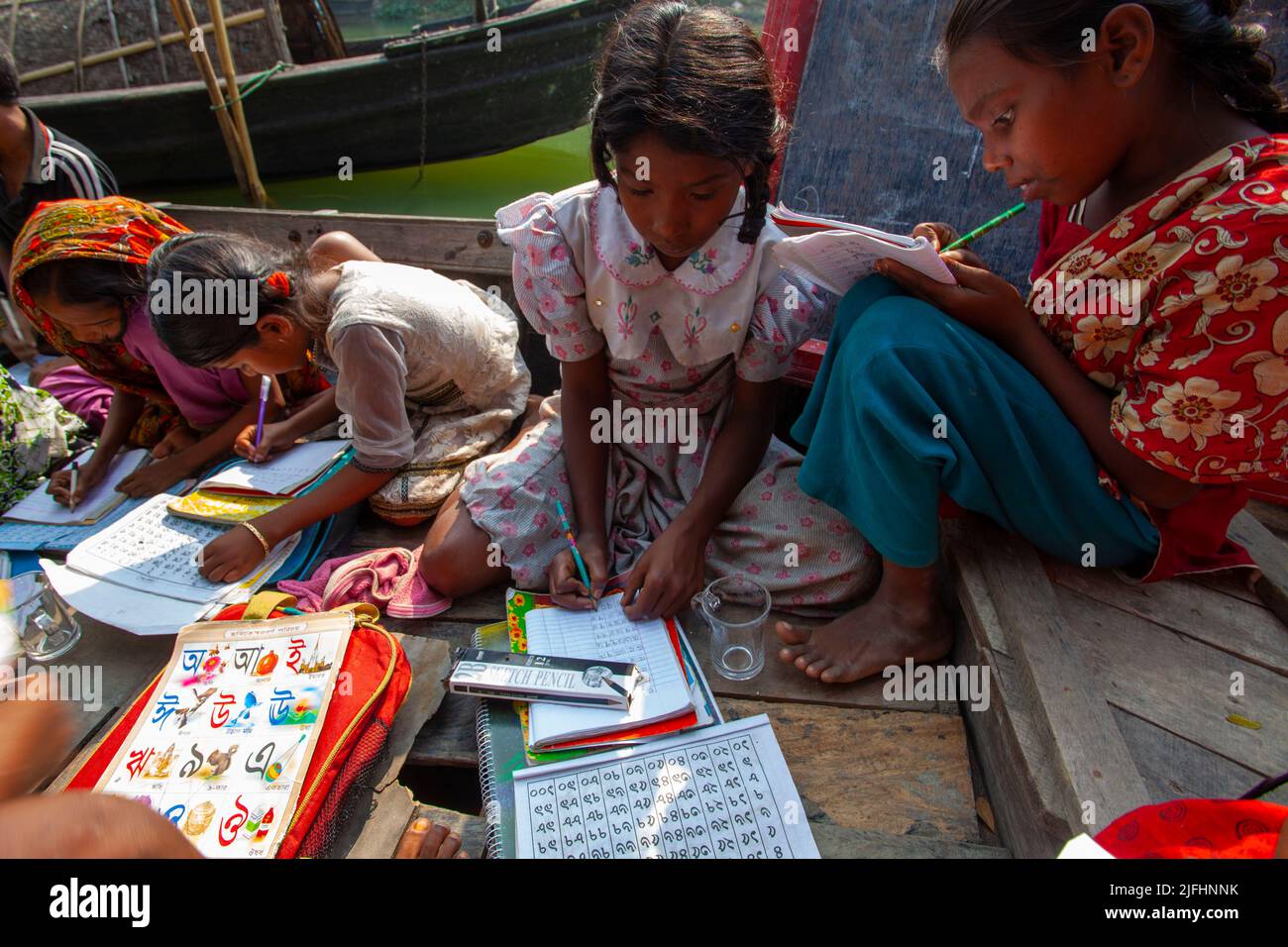 Gypsy children attend at class at a floating school on a canal at ...