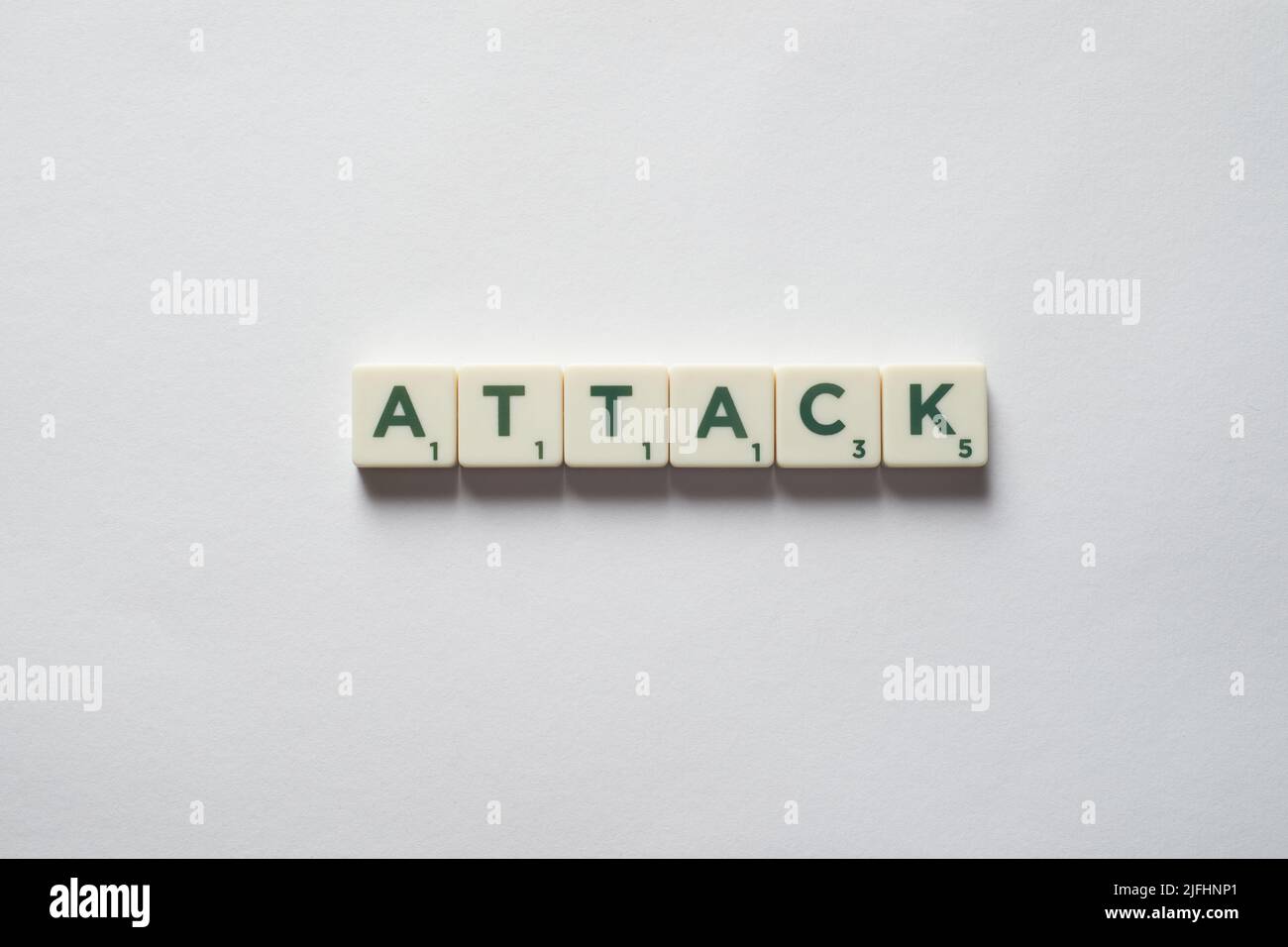 Attack word formed of scrabble blocks on white background. Safety and ...