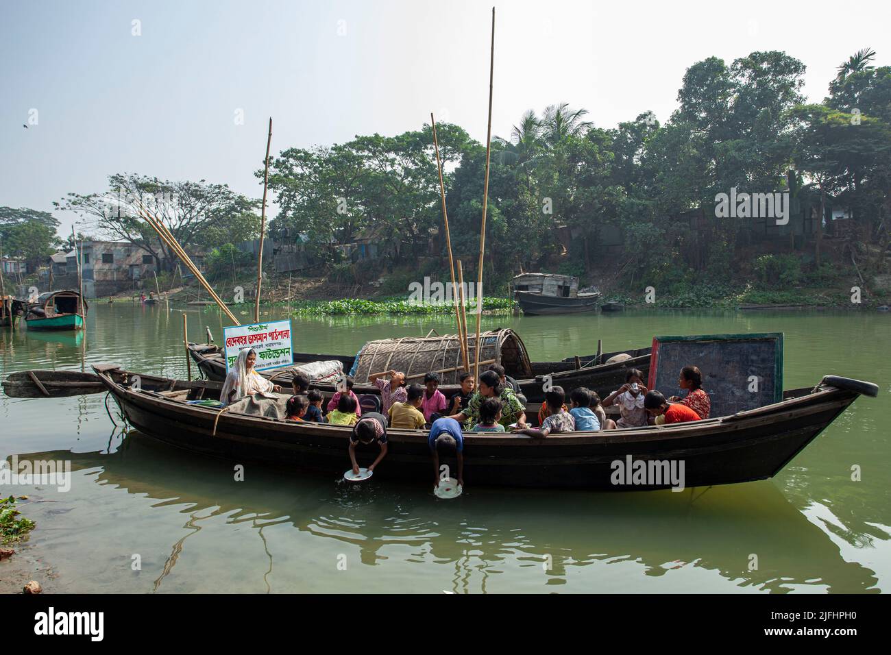 A floating school on a small boat for gypsy children on a canal near ...