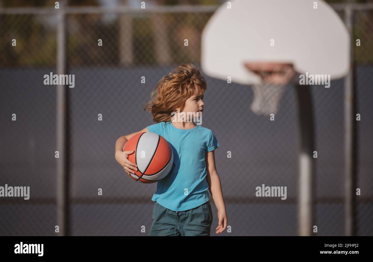 Active kids lifestyle. Little child boy playing basketball with basket ...