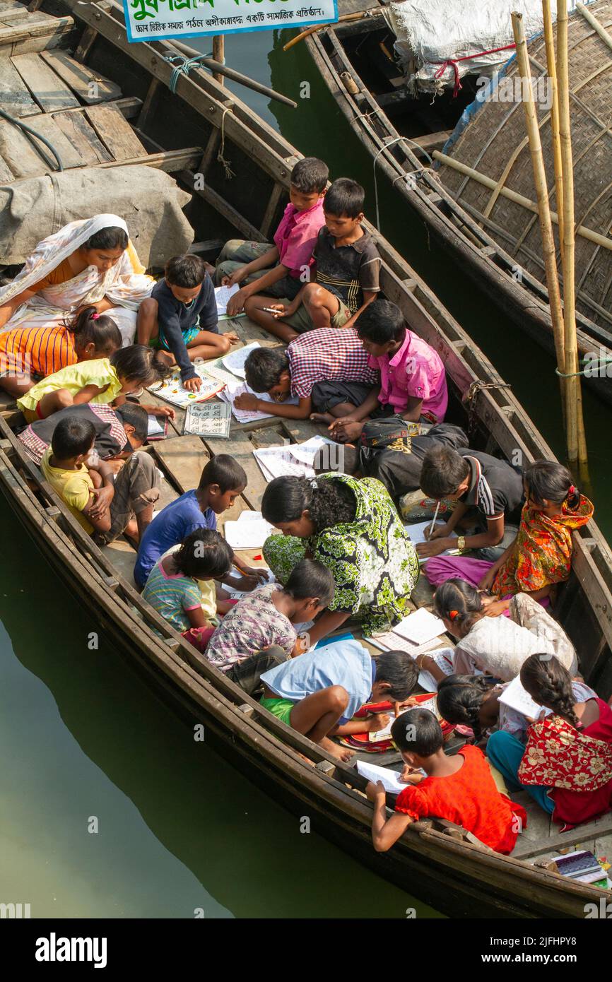 Gypsy children attend at class at a floating school on a canal at ...