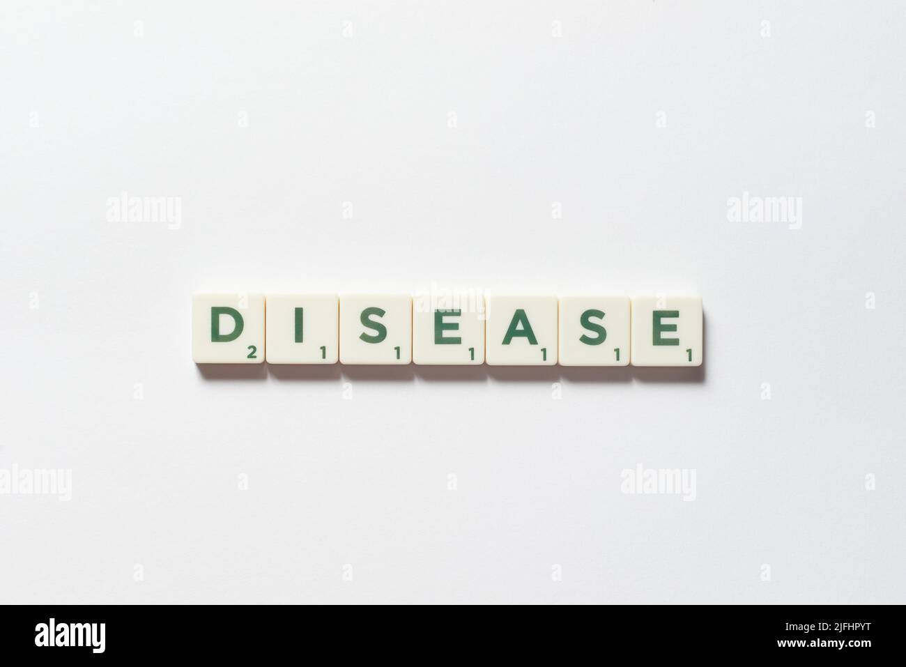 Disease word formed of scrabble blocks on white background. Disease ...
