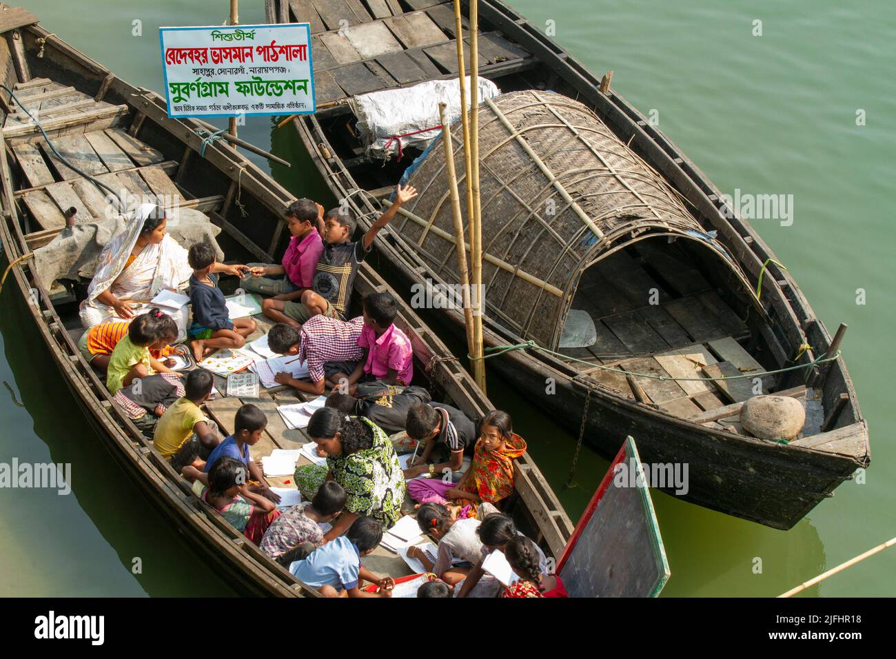 A floating school on a small boat for gypsy children on a canal near ...