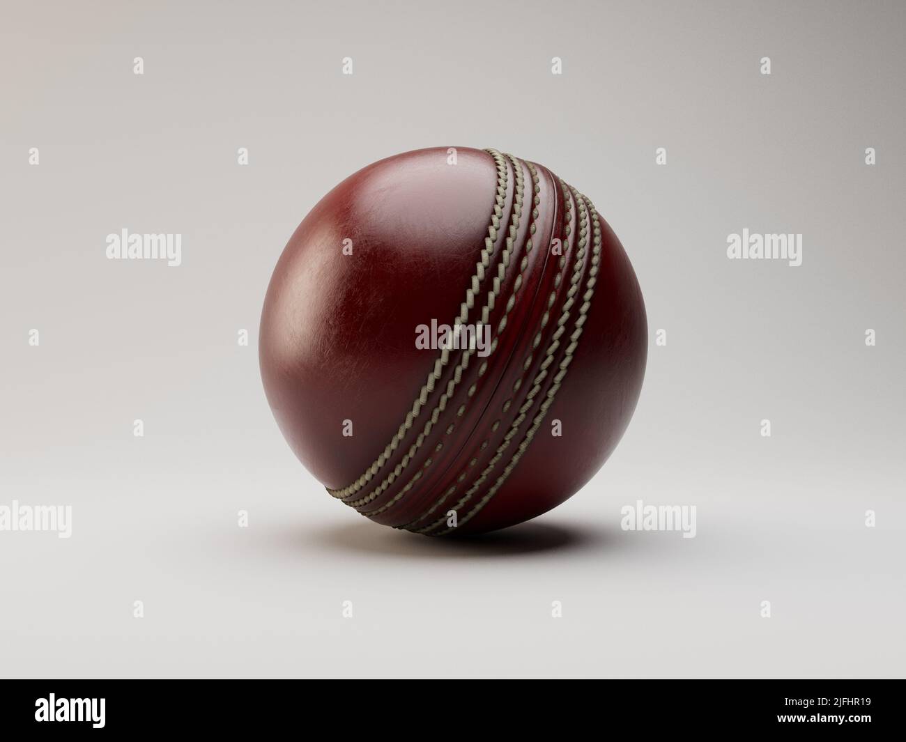 A regular red cricket ball with white stitching on an isolated ...