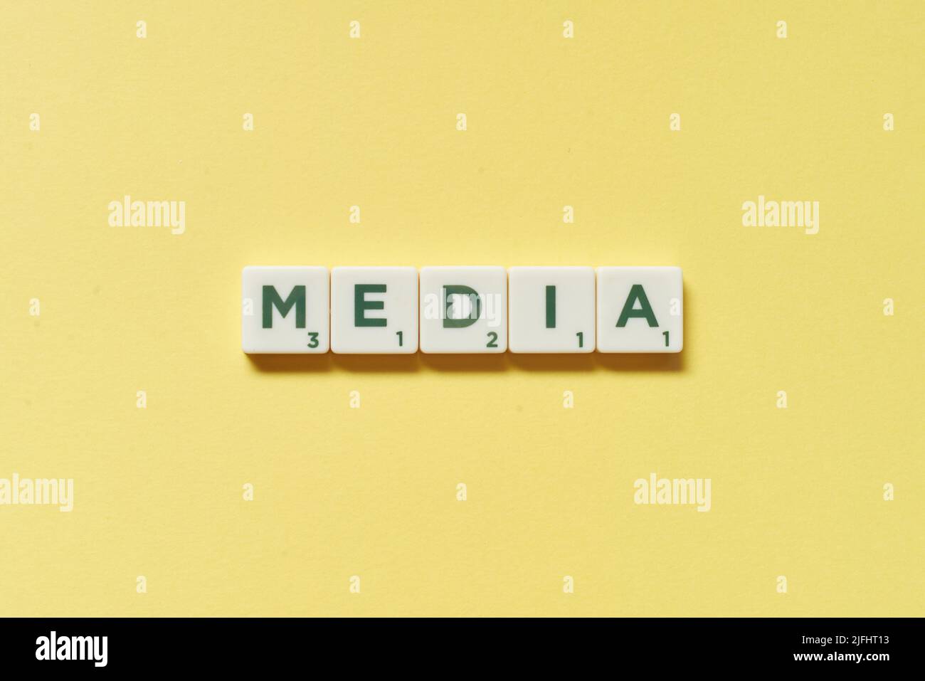 Media formed of scrabble blocks on yellow background Stock Photo - Alamy