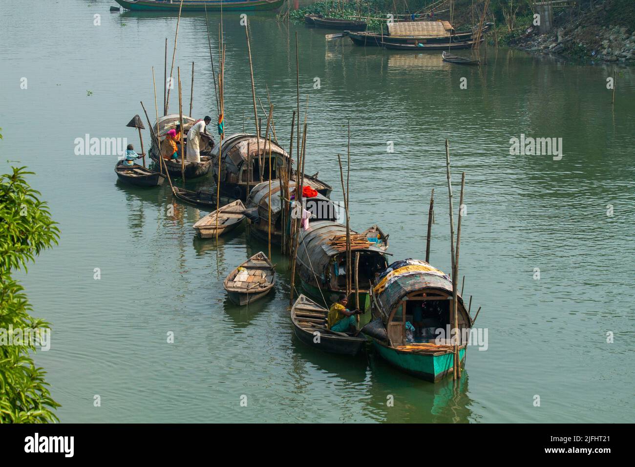 A row of narrowboats belonging to gypsies moored at a canal near Meghna ...