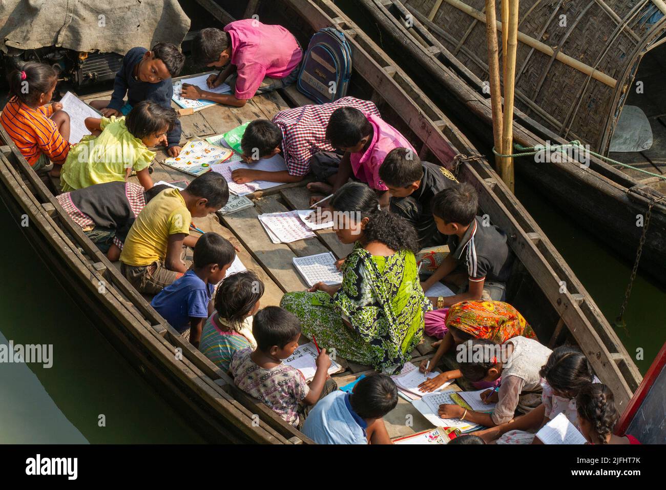 A floating school on a small boat for gypsy children on a canal near ...