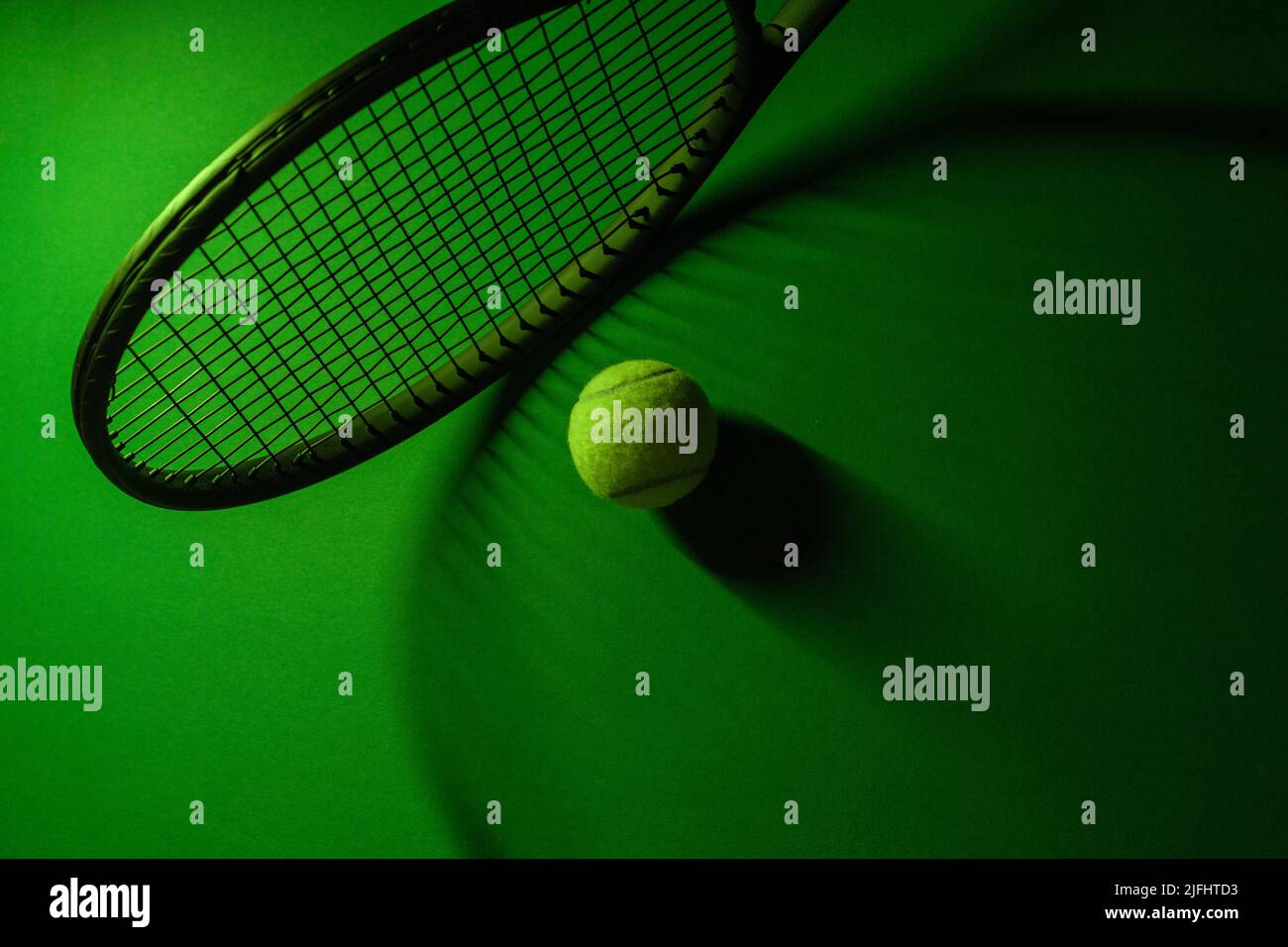 Top view of tennis rackets and ball on green background. Horizontal ...