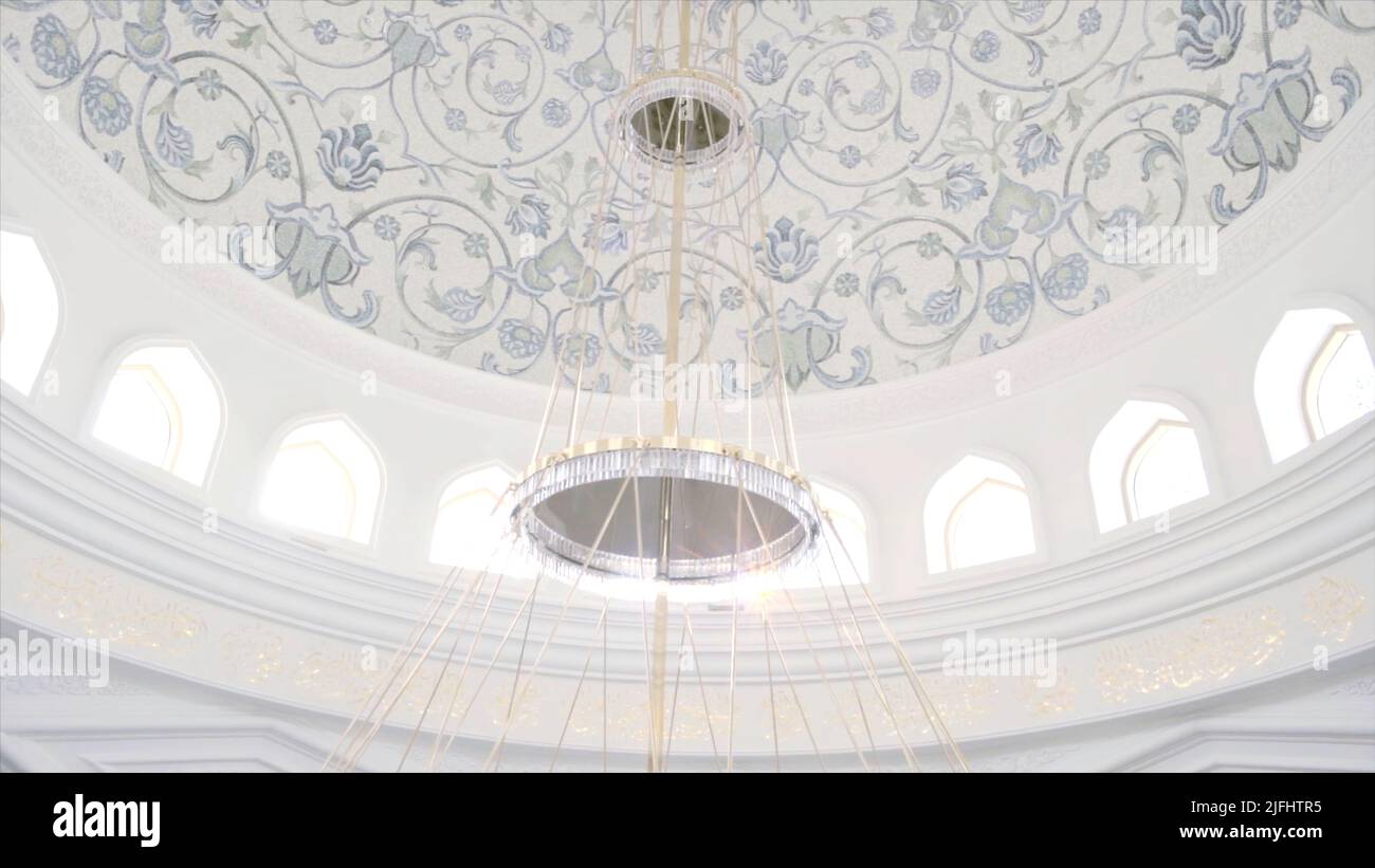 Decorative ceiling and walls with a hanging chandelier. Scene ...