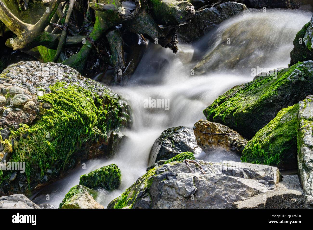 Water flows over rocks at sunset hi-res stock photography and images ...