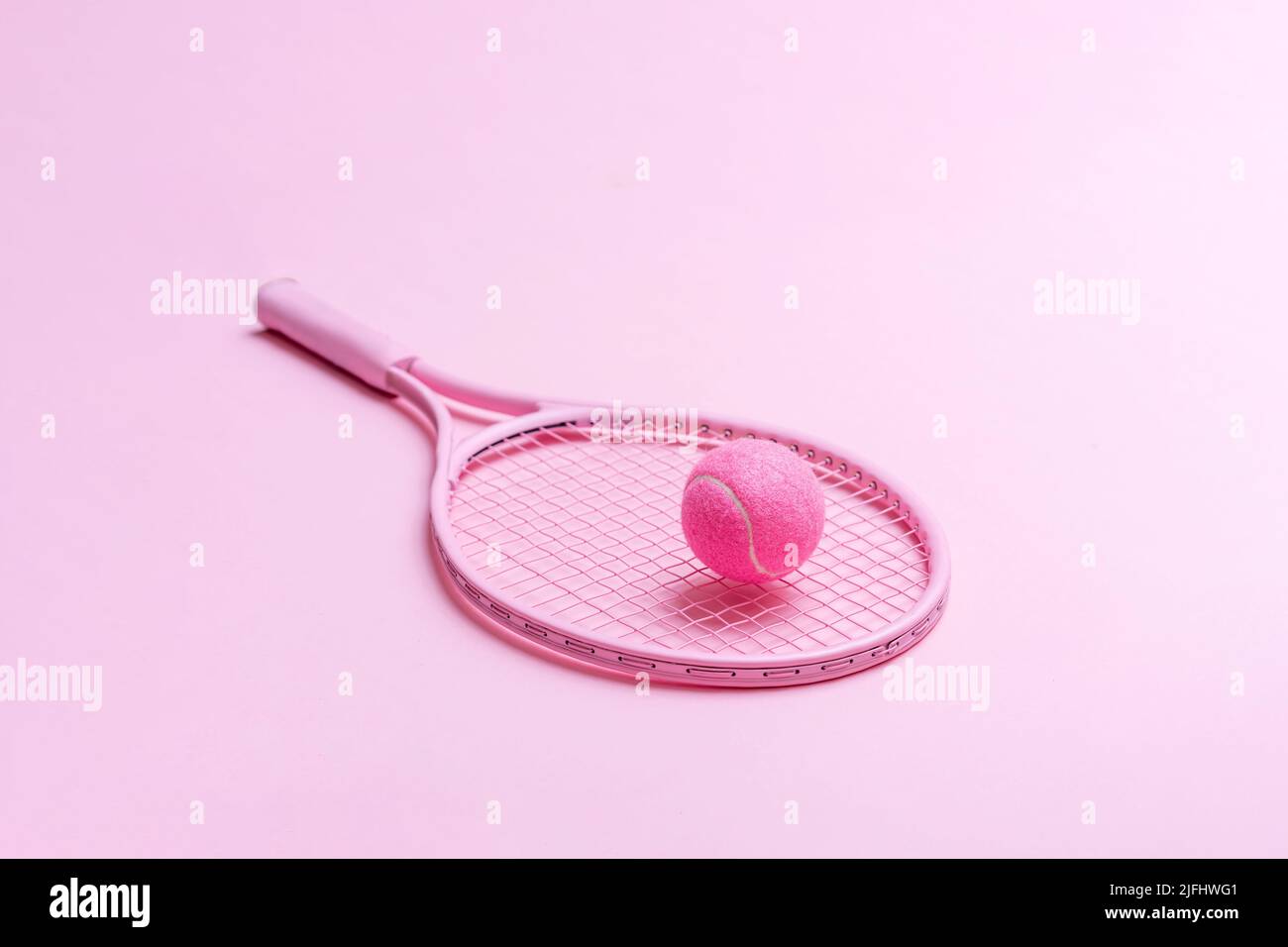 Pink tennis racket and pink ball on pink background. Horizontal sport ...
