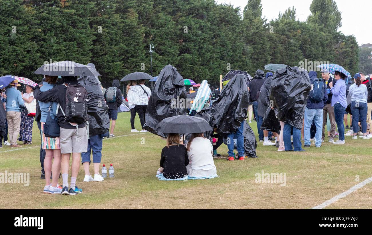 Tennis fans brace rain while queuing at Wimbledon Park ahead of the ...