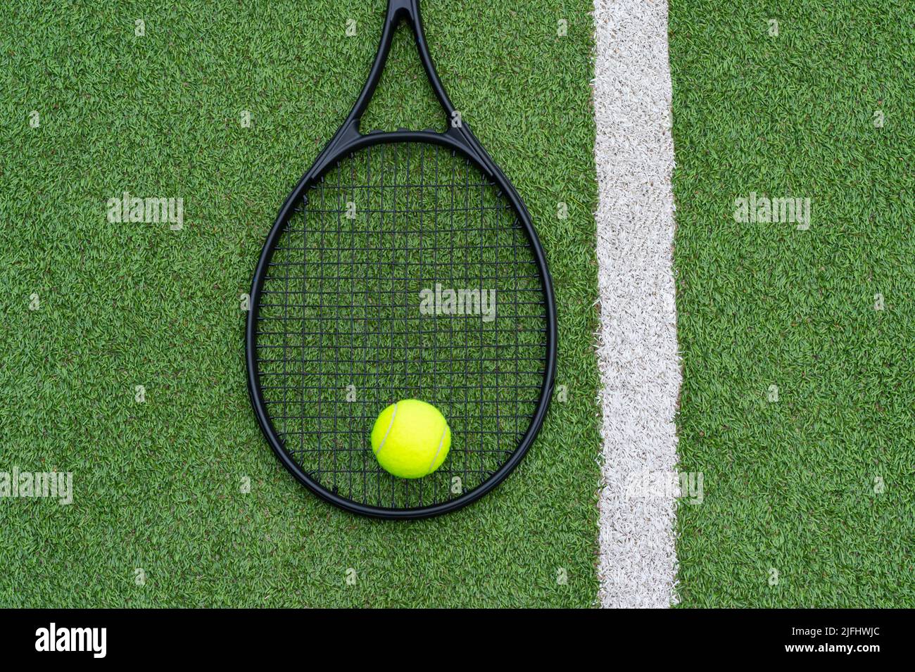 Top view of tennis rackets and ball of green grass. Horizontal sport ...