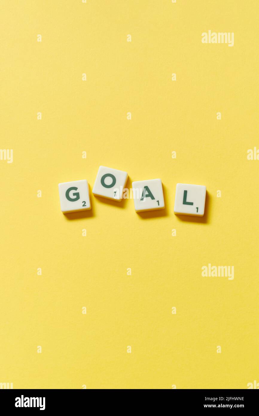 Goal formed of scrabble tiles on yellow background Stock Photo - Alamy