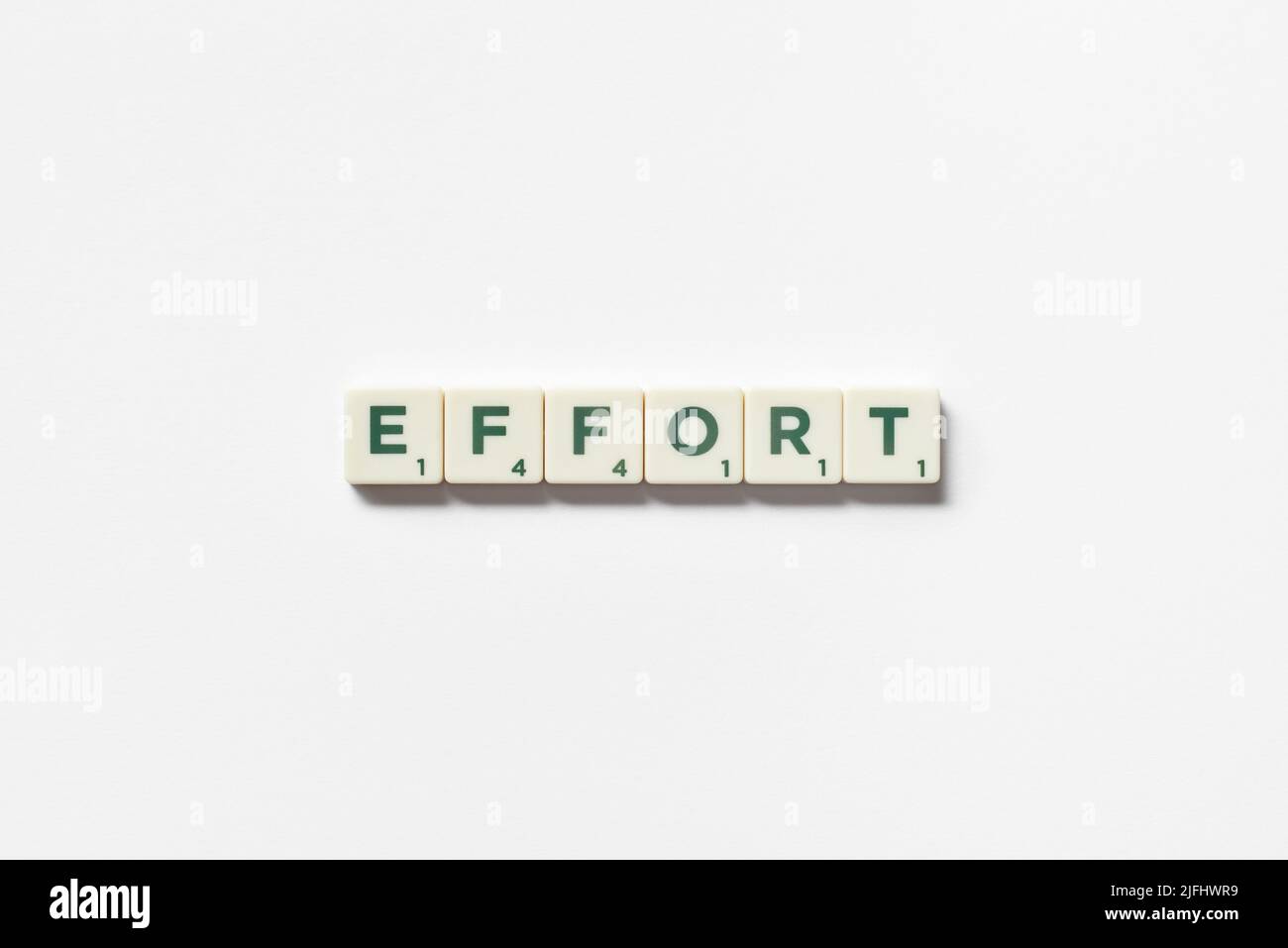Effort formed of scrabble tiles on white background Stock Photo - Alamy