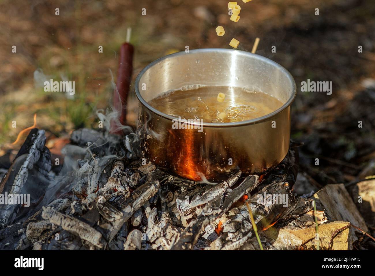 Cooking food in pot on campfire. The concept of adventure, travel ...