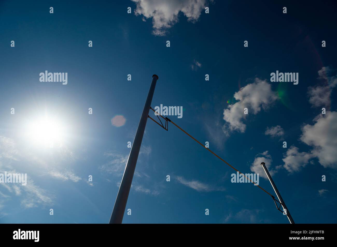 Pole vault against blue sky with sun. Horizontal sport theme poster ...