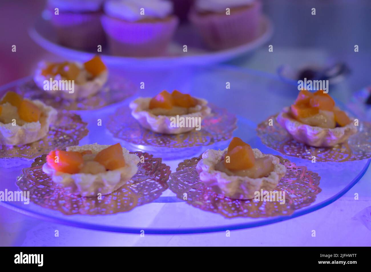 A view of small sweet bites on a glass display in a party event Stock ...